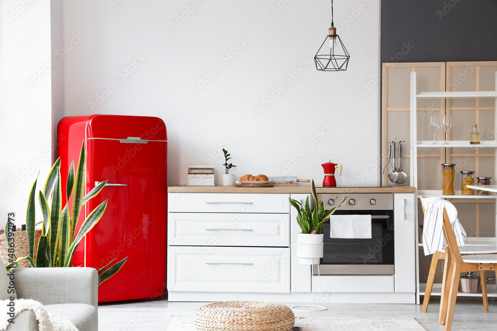 Interior of modern kitchen with red fridge and white counters Stock ...