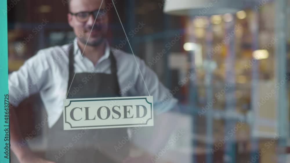 Happy male cafe owner turn open closed sign on glass door. Realtime ...