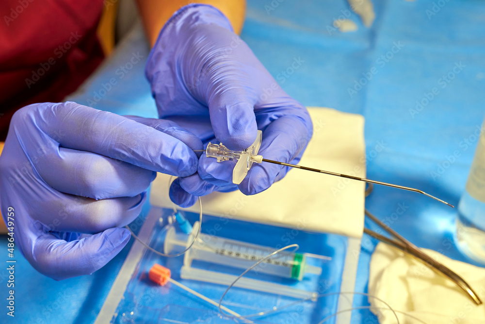 Epidural anesthesia. Tuohy needle in doctor's hands close up Stock ...
