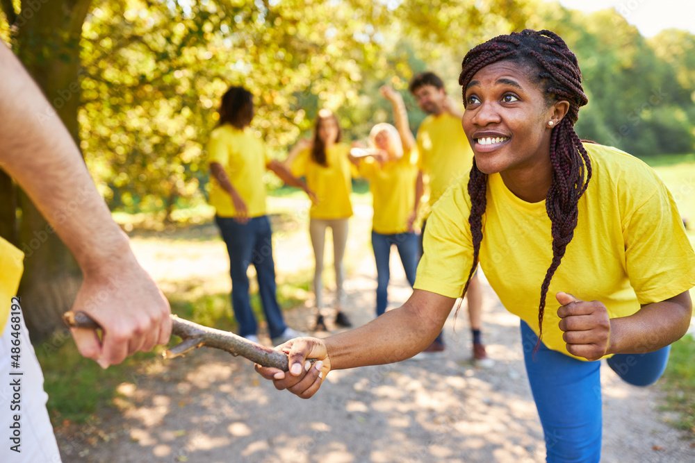 Young woman handing over baton at a foot race Stock Photo | Adobe Stock