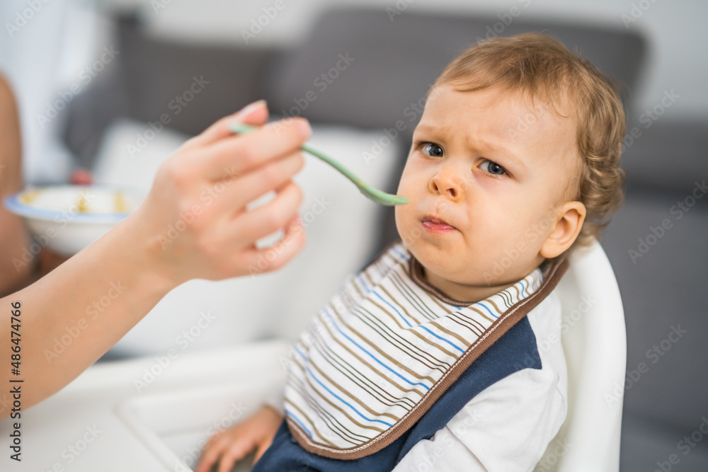 Foto de Angry baby boy doesn't want to eat. do Stock | Adobe Stock