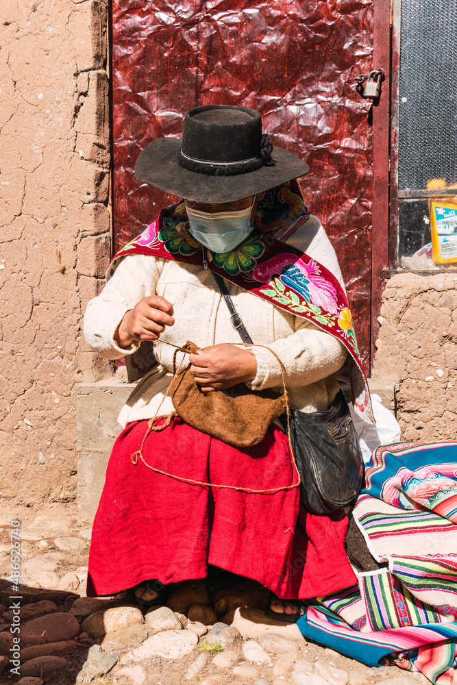 poor indigenous adult woman artisan with blue mask and typical ...