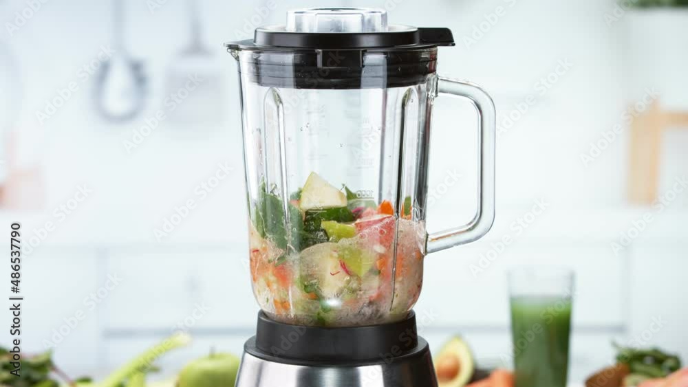 Super slow motion of mixing pieces of fruits and vegetables in blender ...