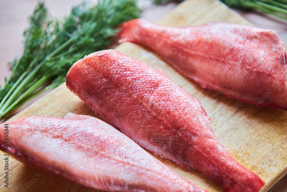 The fish is a red sea bass without a head. Raw frozen foods. A delicacy ...