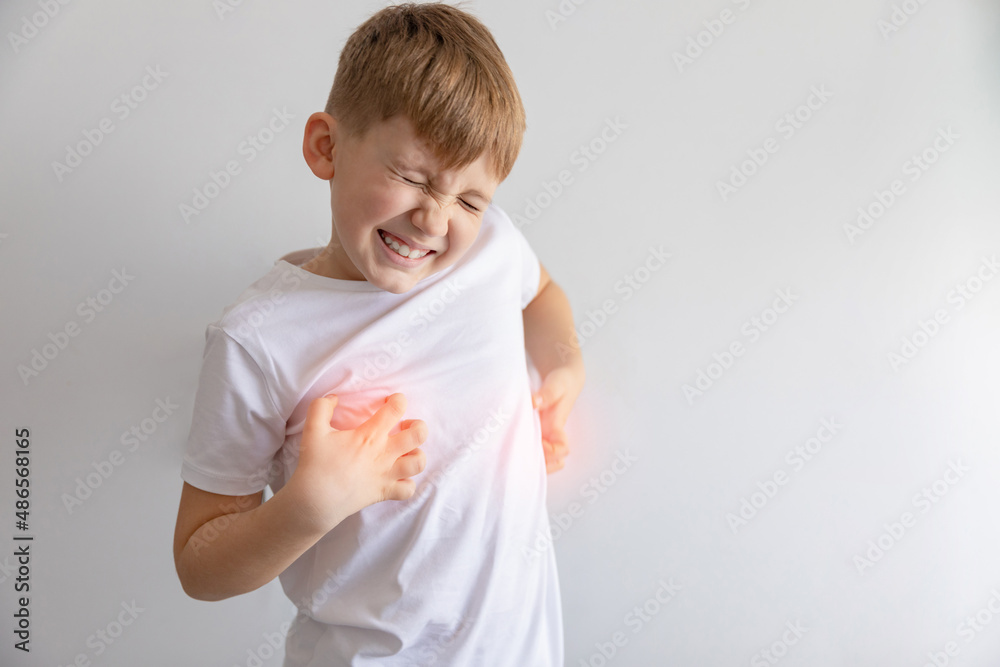 Kid boy in white t-shirt isolated on white background scratching his ...
