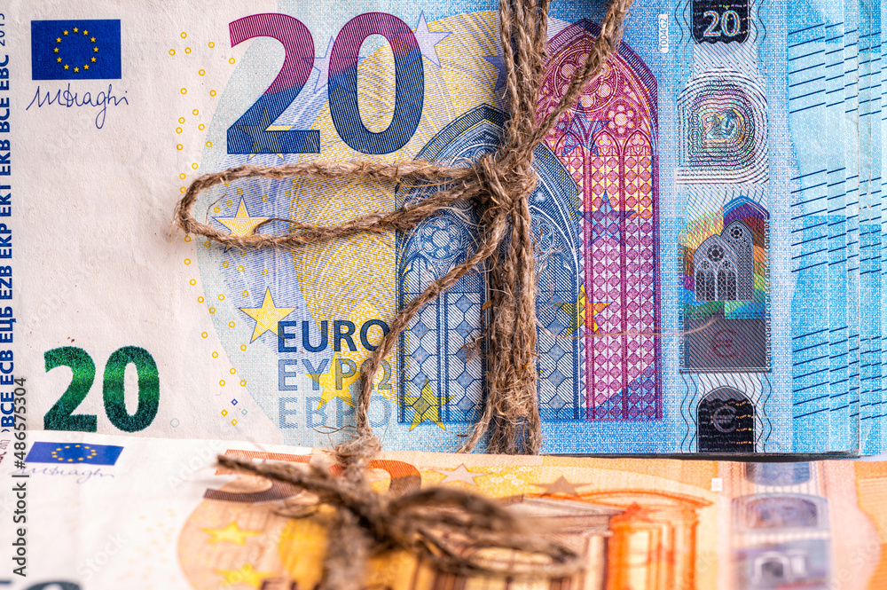 stack of euro banknotes tied with burlap string, close-up, wealth and ...