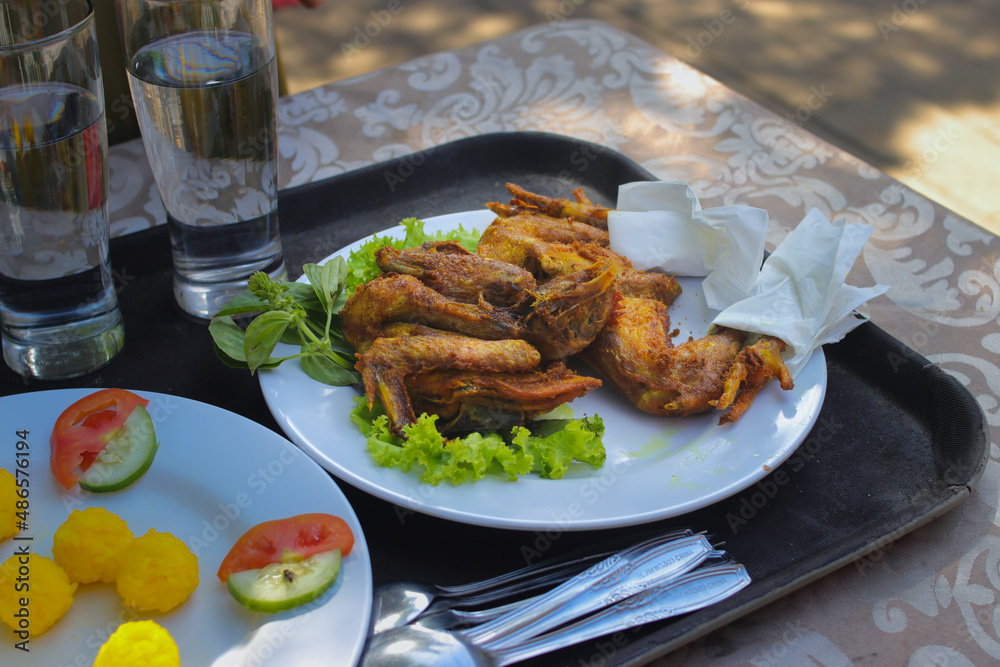 Ayam Bekakak or Grilled Whole Chicken with fresh vegetables on white ...