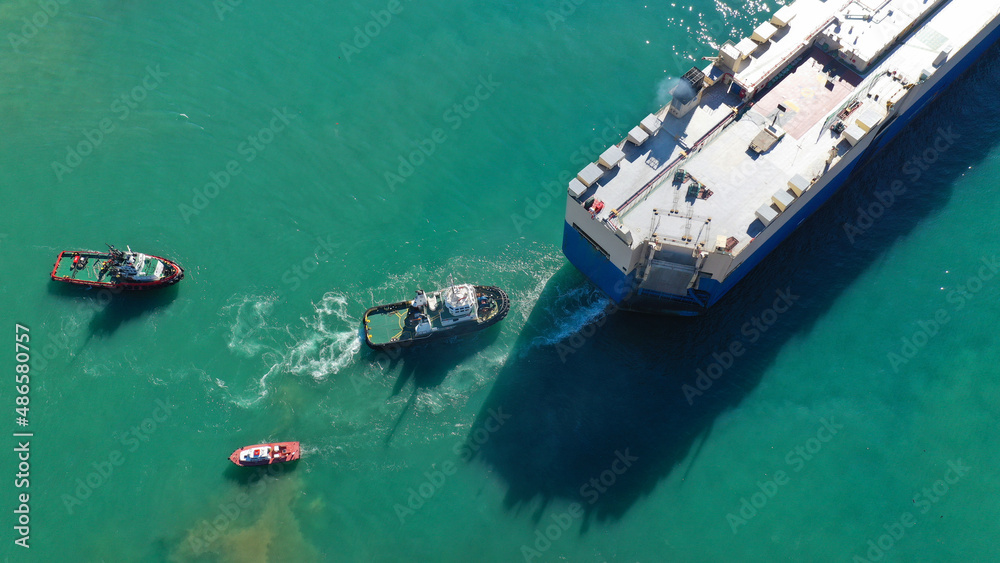 Aerial drone photo of large car carrier ro ro vessel guided by tug ...