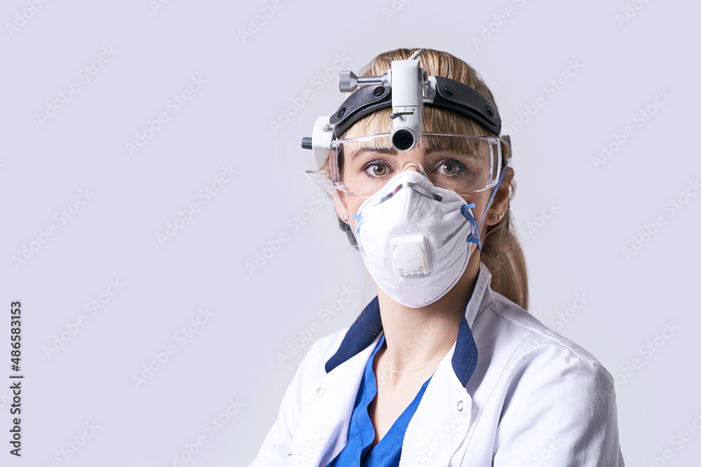 Confident ENT doctor wearing surgical headlight head light and ...