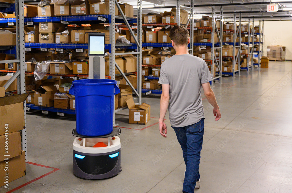 Manager walking with picking Robot in warehouse Stock Photo | Adobe Stock
