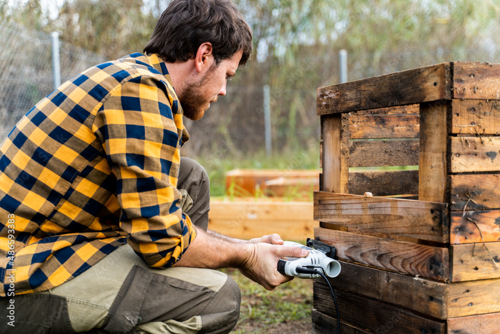 Man constructing recycle wood planters Stock Photo | Adobe Stock