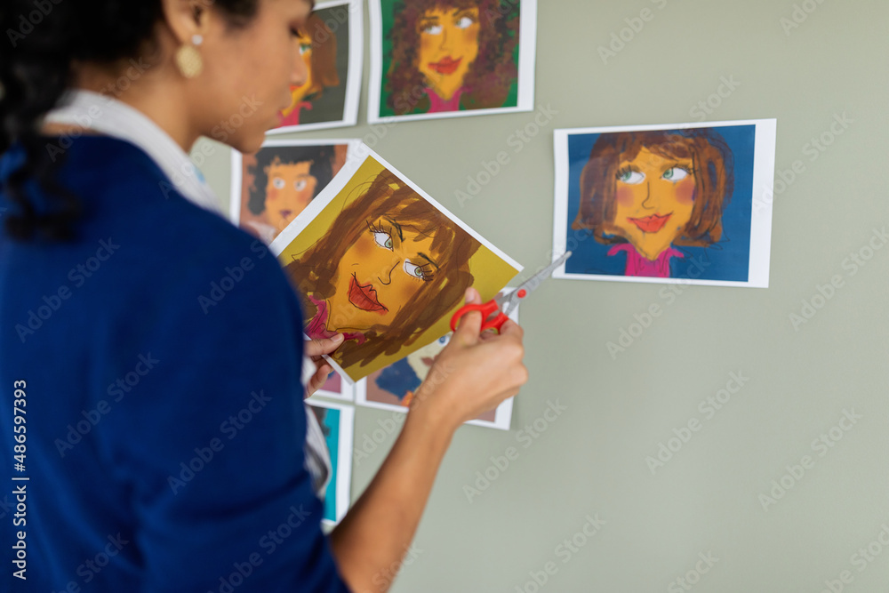 Artist cutting illustration with scissors in her studio Stock Photo ...