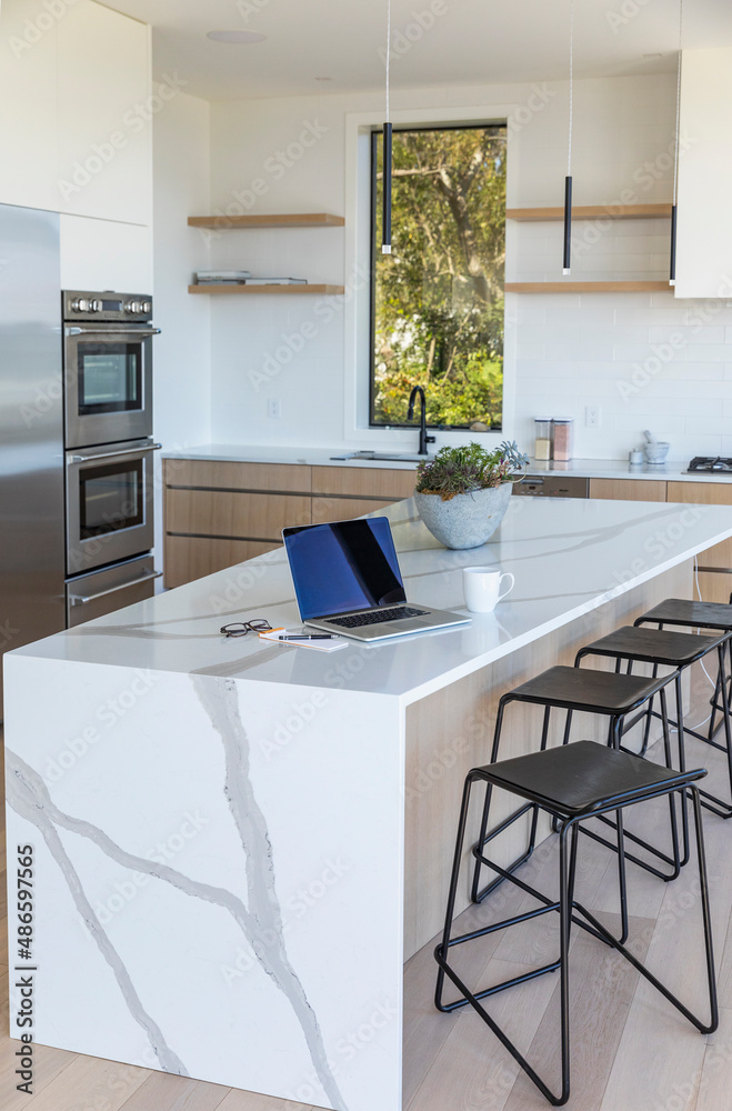 Laptop Computer screen on kitchen island in Home Stock Photo | Adobe Stock