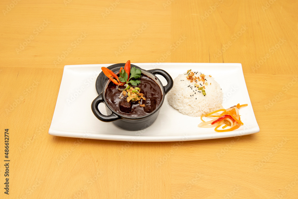 a rich, spiced gravy of pig's blood, garlic, chili, and vinegar. The ...