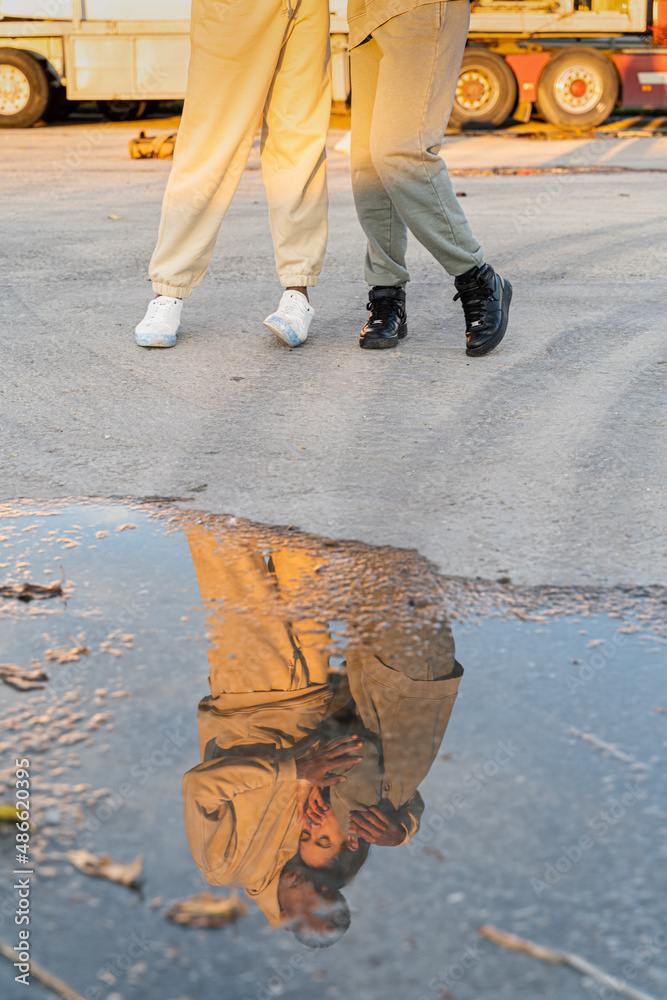 Puddle reflection of couple hugging outdoors Stock Photo | Adobe Stock