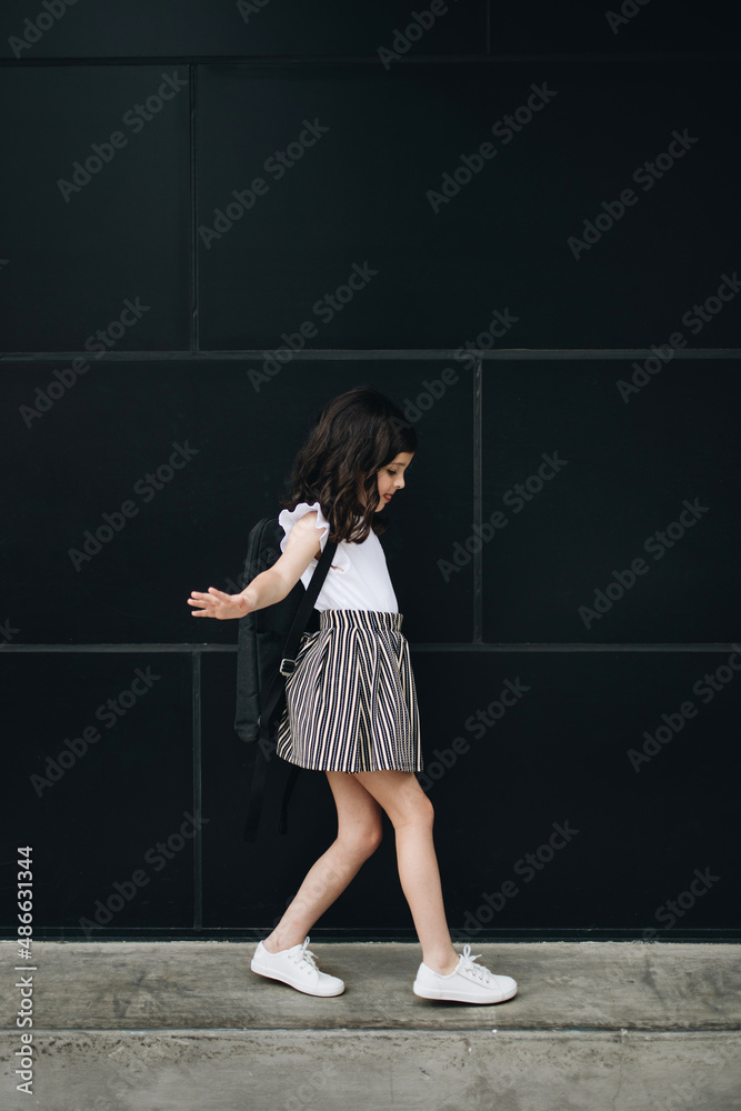 Young girl wearing a backpack Stock Photo | Adobe Stock