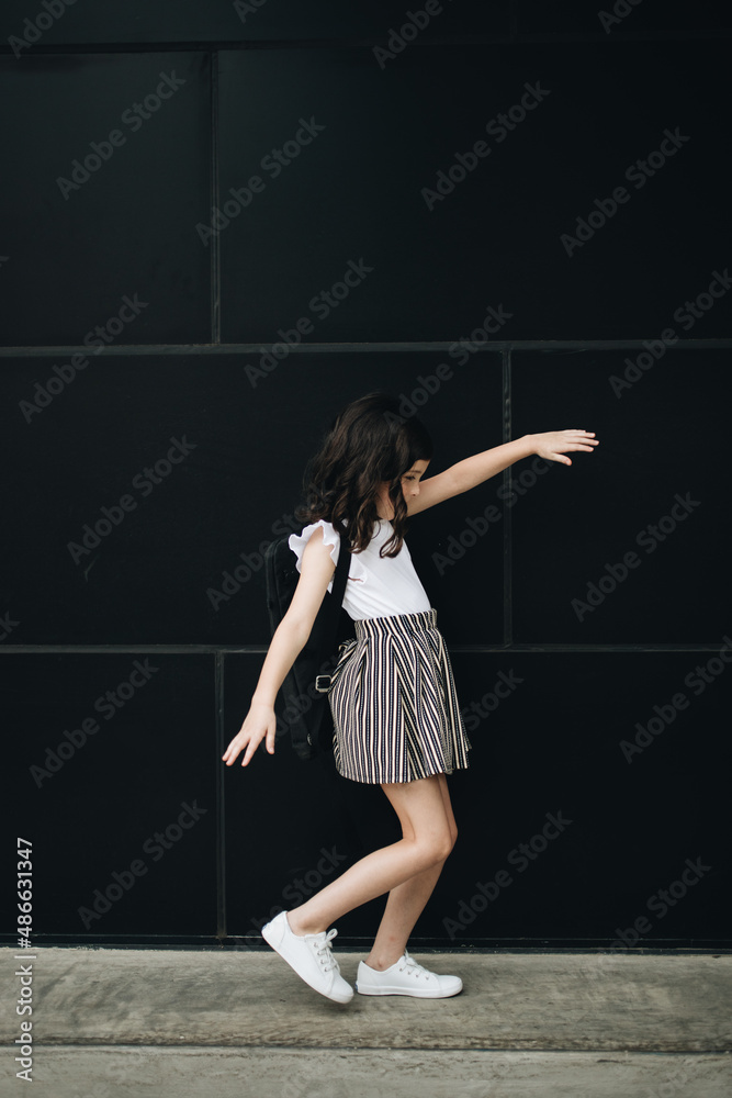 Young girl wearing a backpack Stock Photo | Adobe Stock