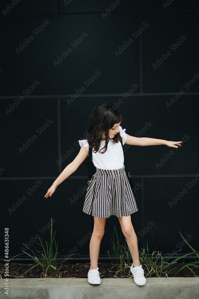 Young girl wearing a backpack Stock Photo | Adobe Stock