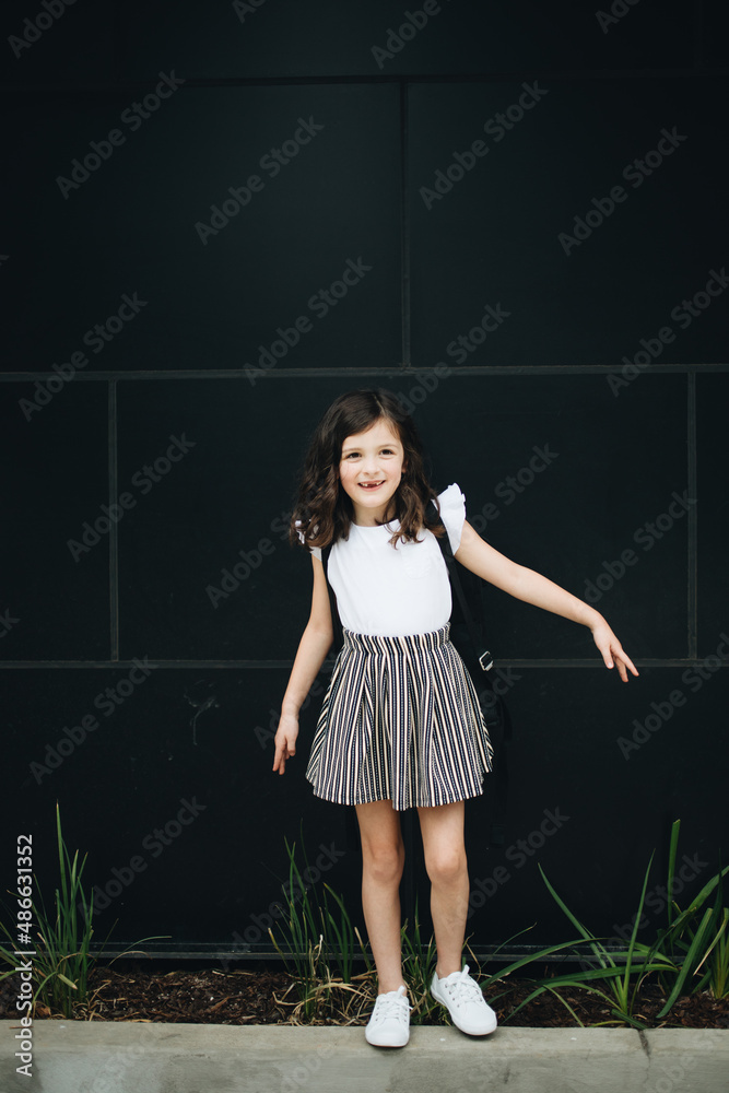 Young girl wearing a backpack Stock Photo | Adobe Stock