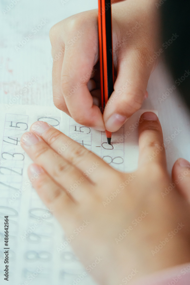 Child girl writing math numbers Stock Photo | Adobe Stock