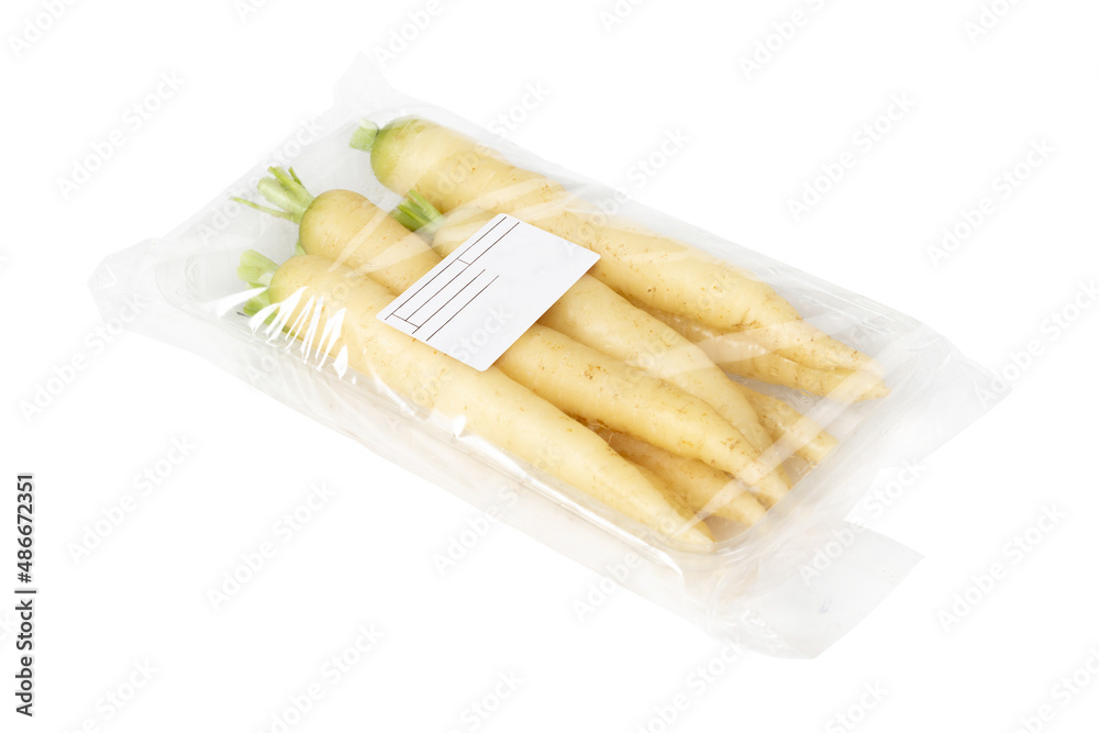 Packaged and labeled parsnip or yellow carrot on an isolated white ...