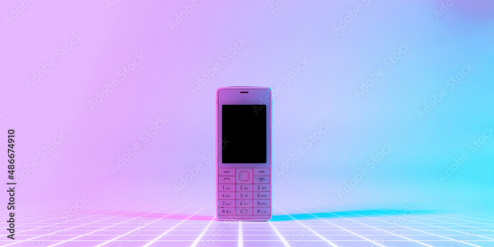Retro cell phone vintage concept. White old mobile telephone in neon ...