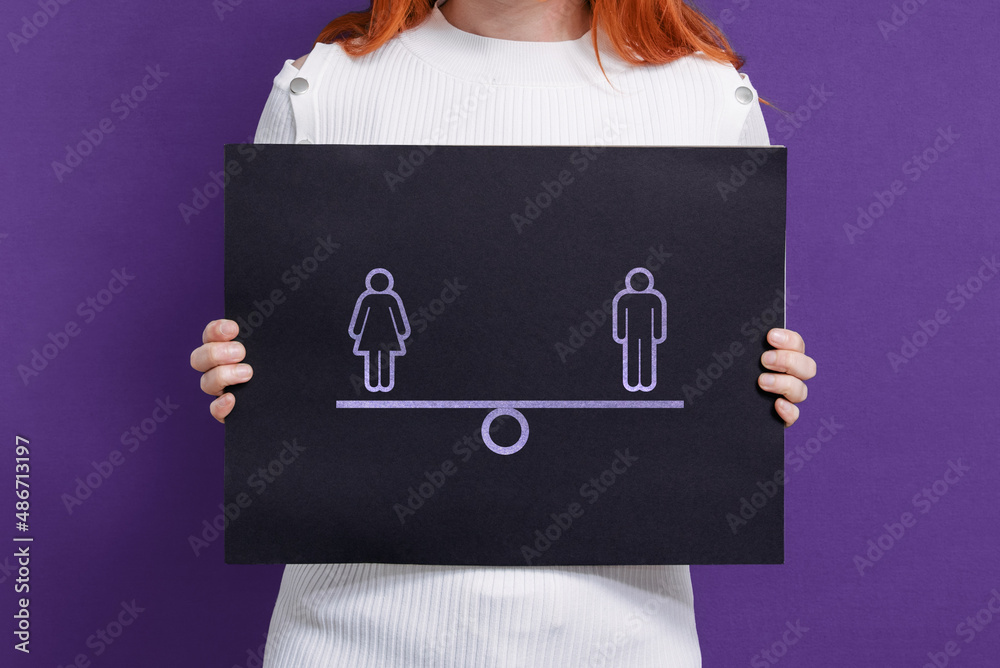 Girl with feminist poster on gender equality on a purple background ...