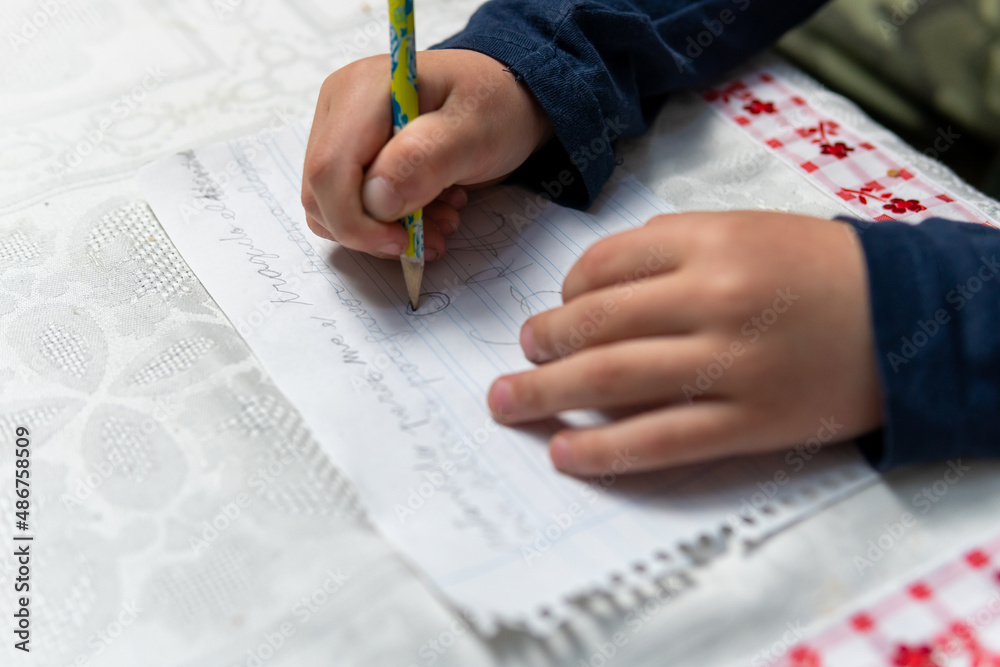Young excited boy writing a handwritten letter with his favorite pencil ...