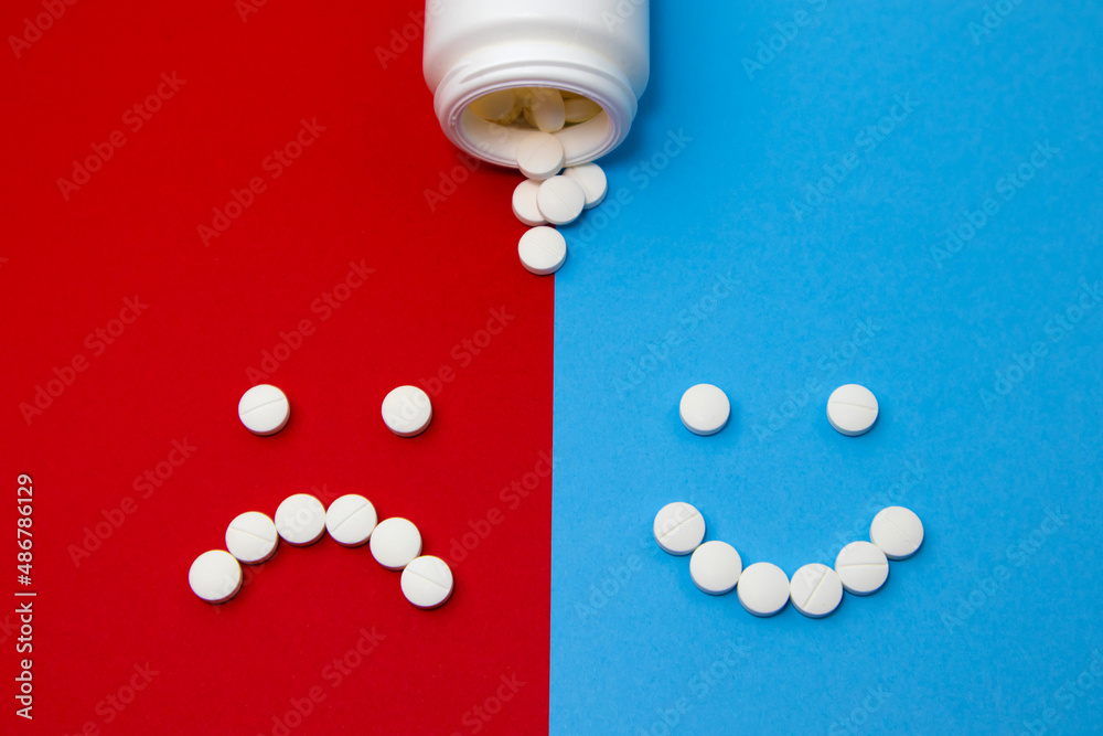 Pills smileys. Happy and sad smileys made of pills and a plastic bottle ...