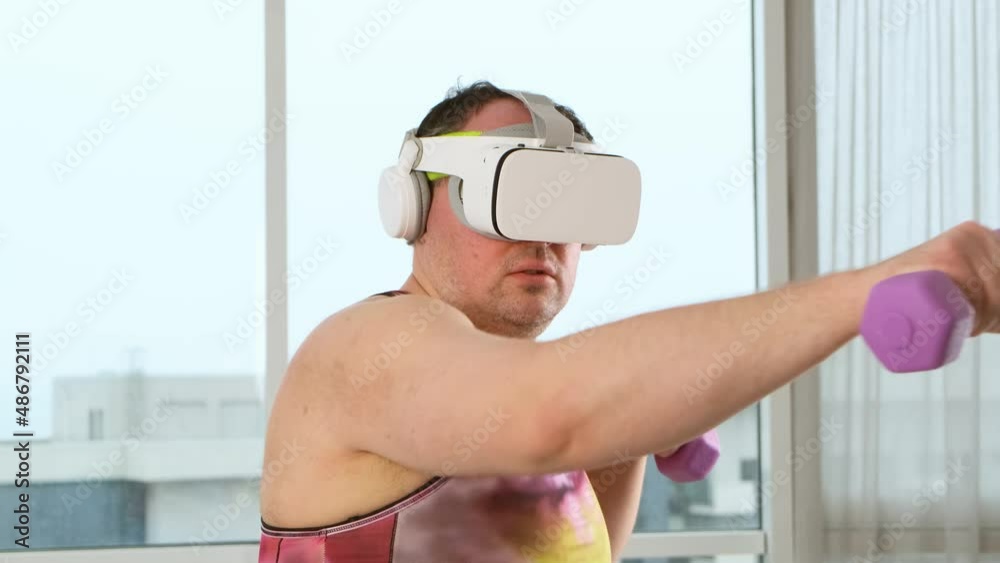 Overweight sporty man doing a weight training exercise by using ...