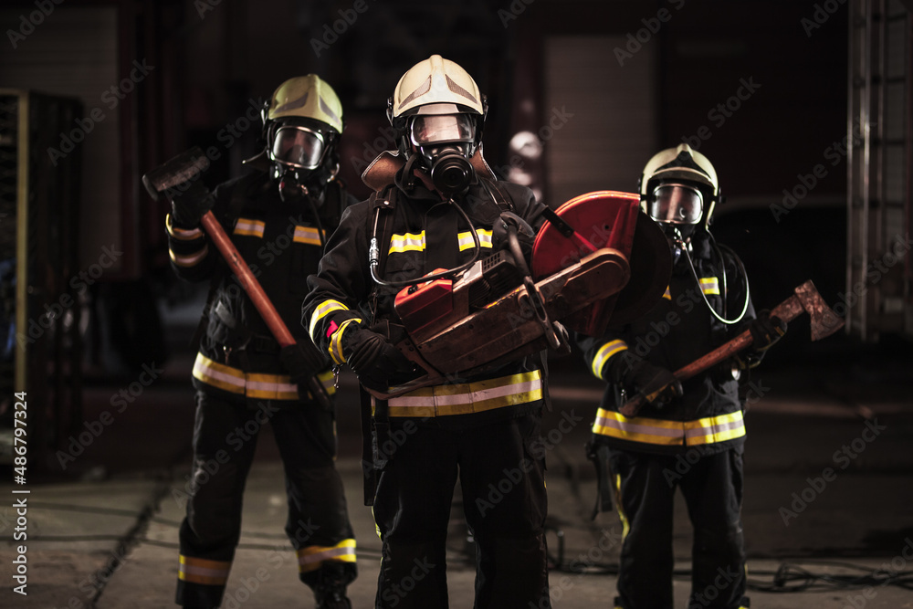 Group of professional firefighters wearing full equipment, oxygen masks ...