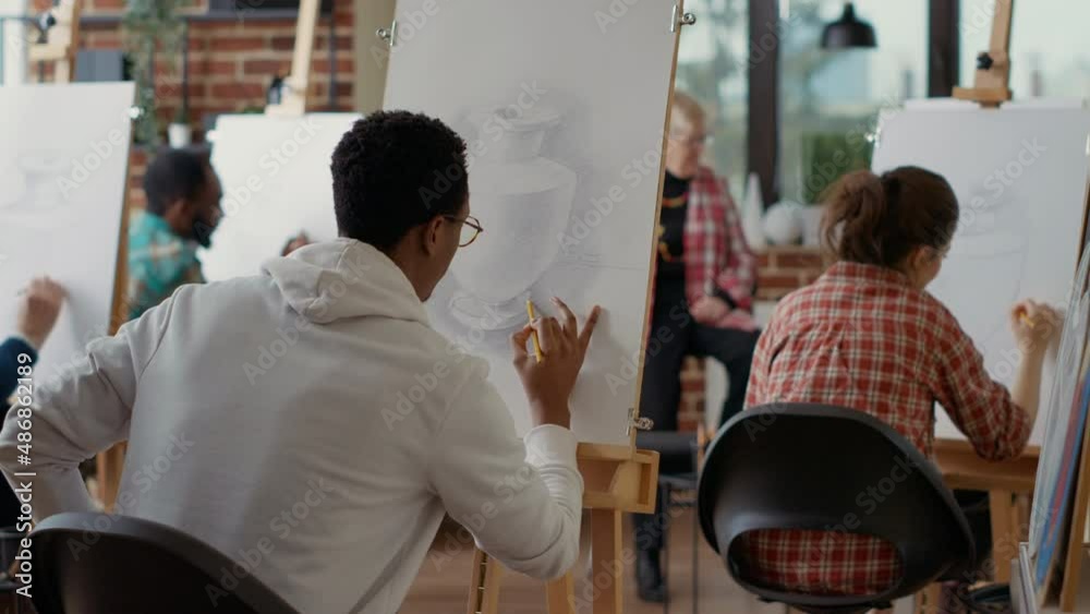 African american student drawing contemporary sketch in art class ...