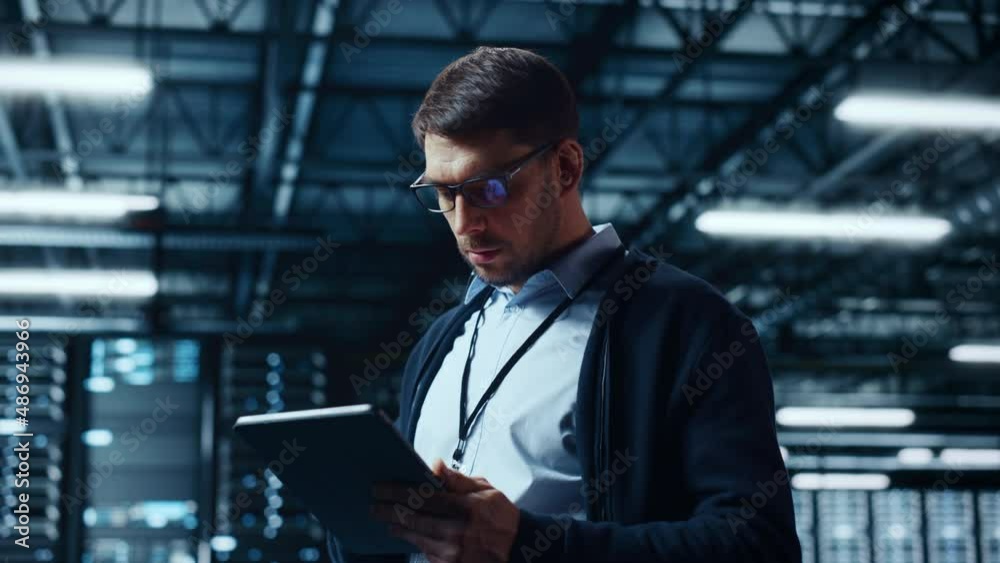 Male IT Specialist Walks Between Row of Operational Server Racks in ...