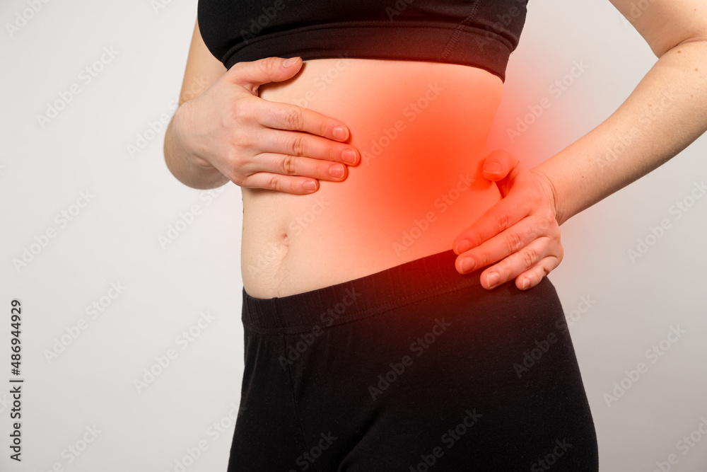 A woman shows the location of the pancreas and spleen, the large ...
