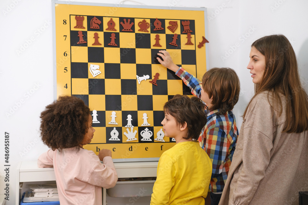 Child Thinking Hard On Chess Combinations on the wall on tournament for ...