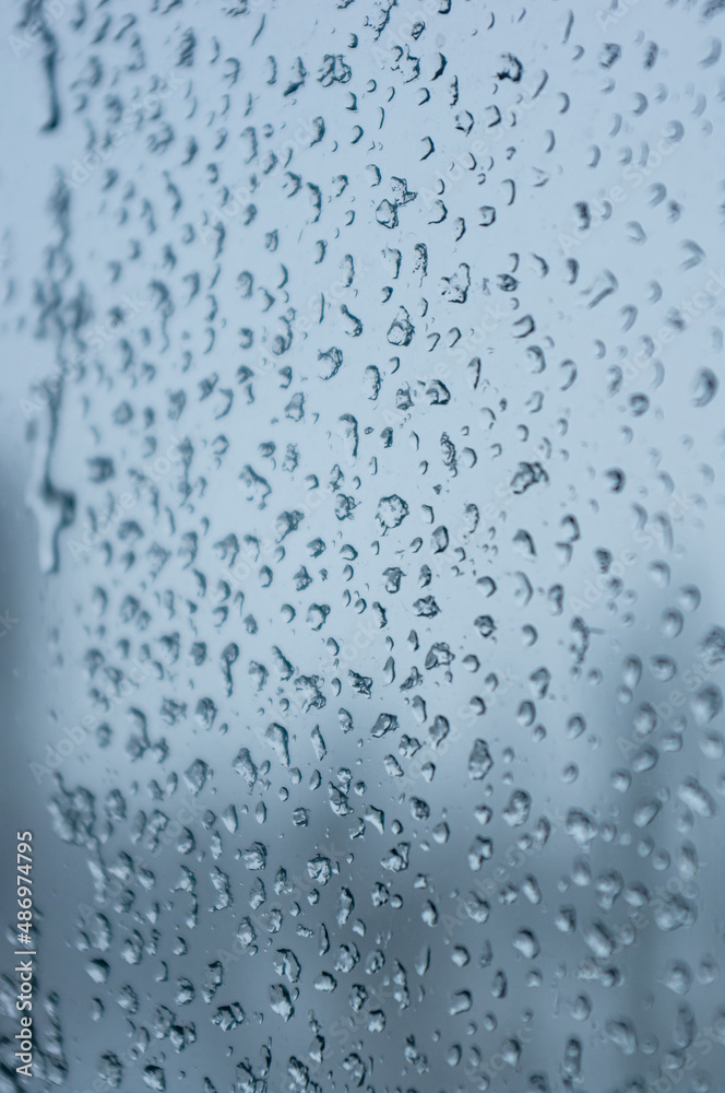 Melting snow on the glass, drops of water condensation on the window ...