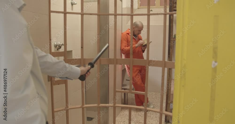 prison guard brings the letter to the prisoner. delivery of letters in ...