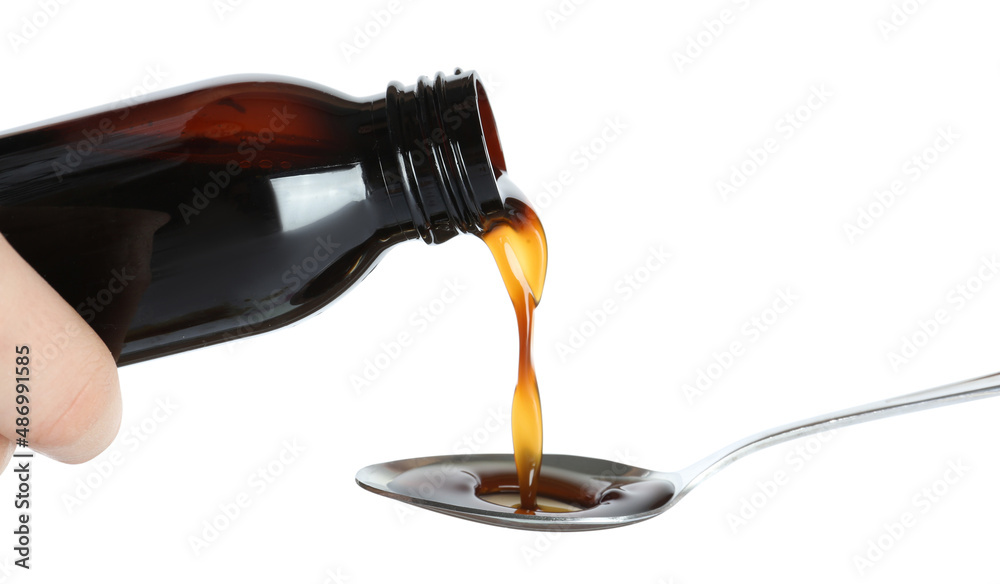 Pouring cough syrup into spoon on white background Stock Photo | Adobe ...