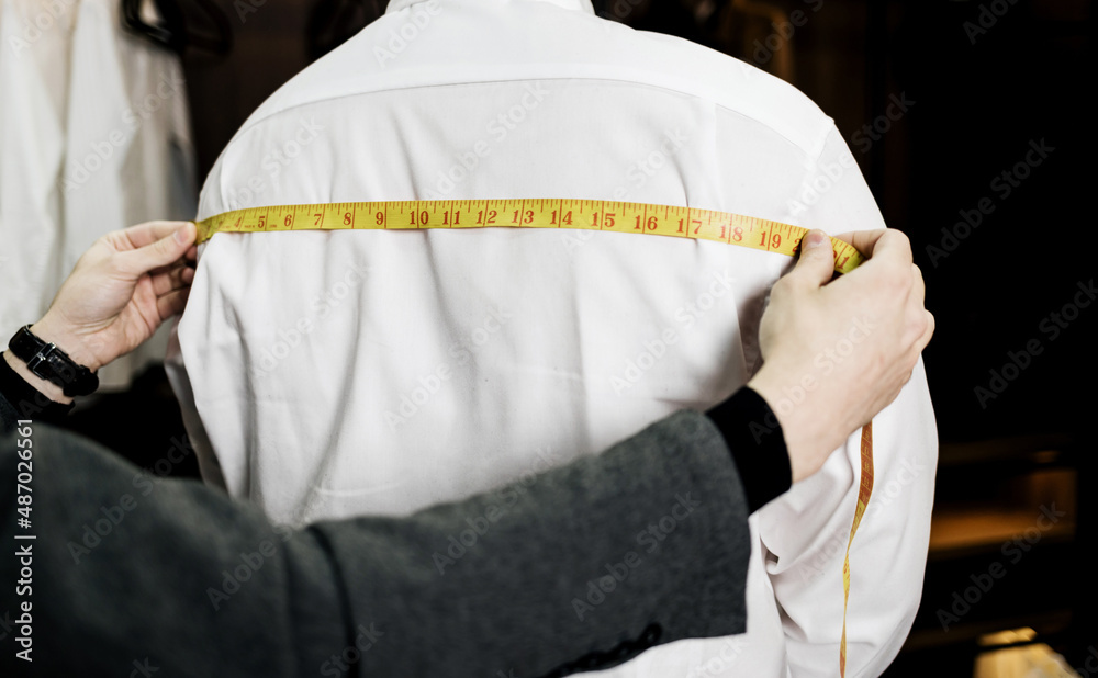 tailor takes measurements Stock Photo | Adobe Stock