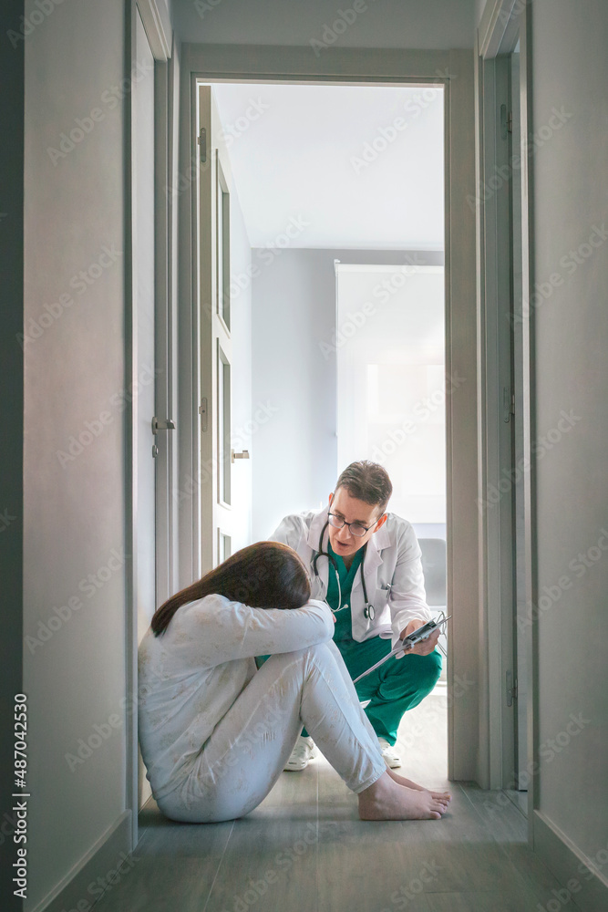 Psychiatrist talking to female patient with mental disorder sitting on ...