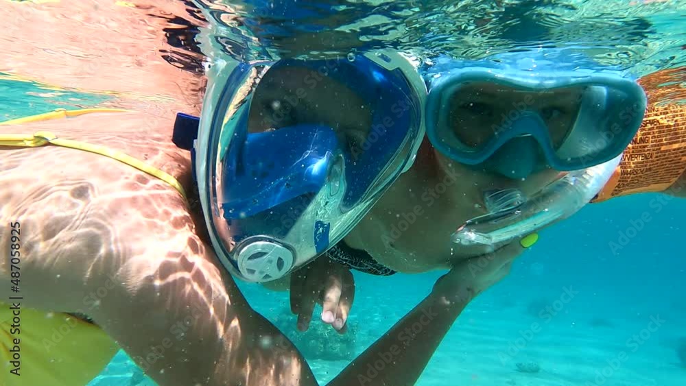 Swimming in the Red Sea during the summer holidays. Child with his mom ...