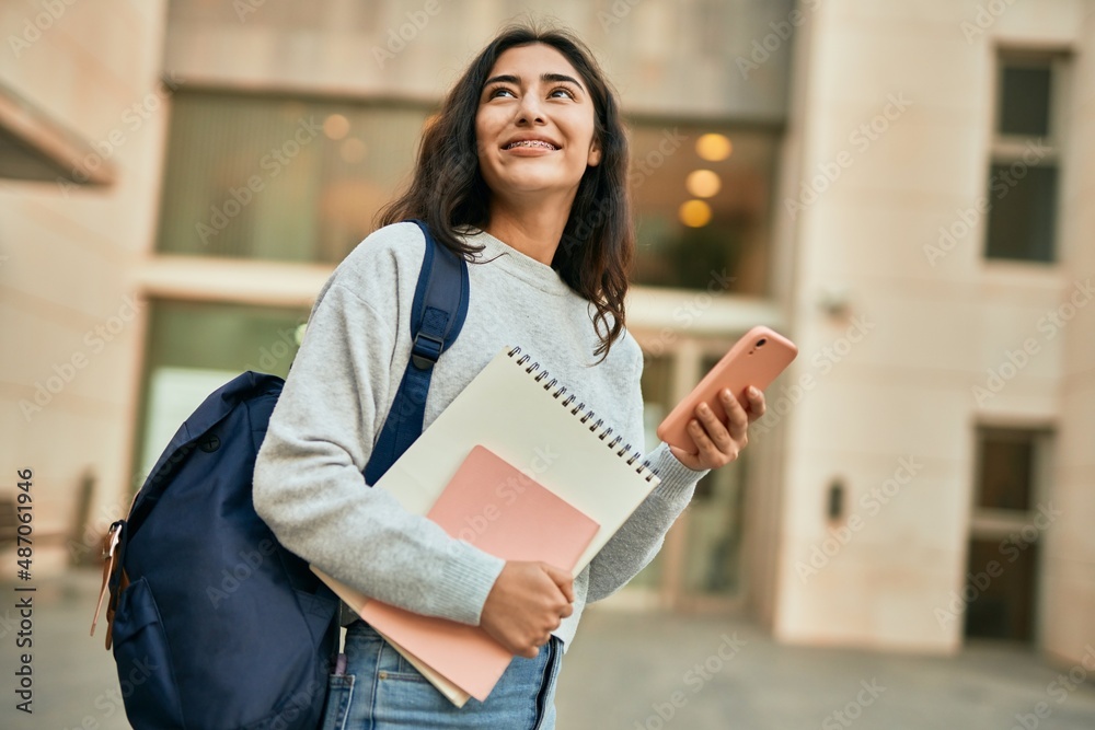 Young middle east student girl smiling happy using smartphone at the ...