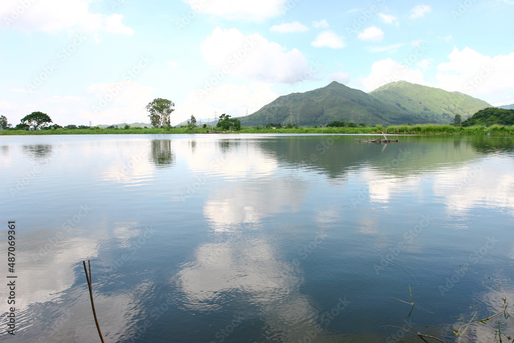 Reflection of the Kai Kung Leng, at Shan Pui Tsuen fish pond. Stock ...