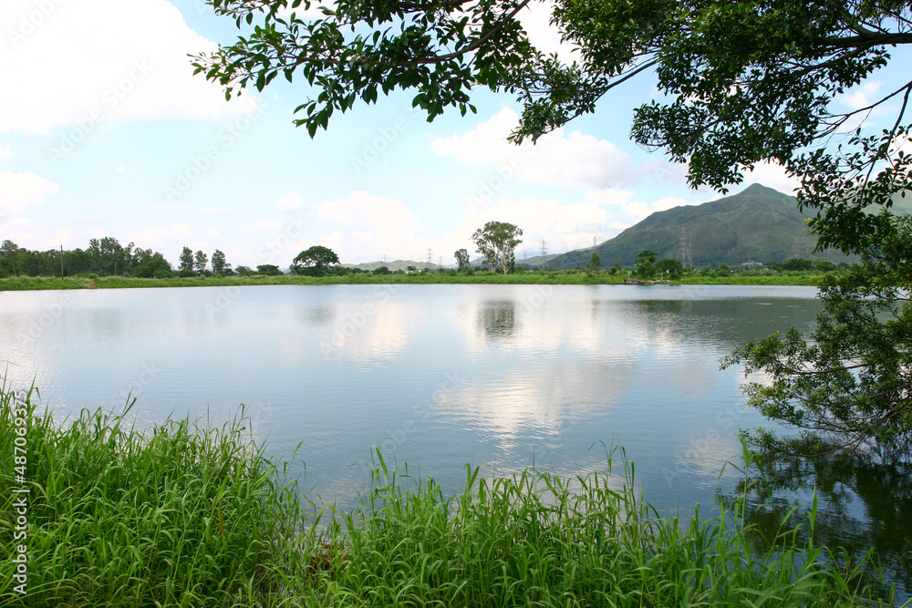 Reflection of the Kai Kung Leng, at Shan Pui Tsuen fish pond. Stock ...