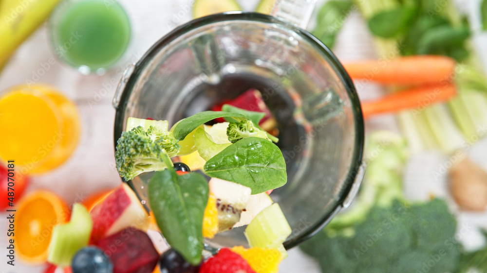 Falling pieces of fruits and vegetables into blender. Stock Photo ...