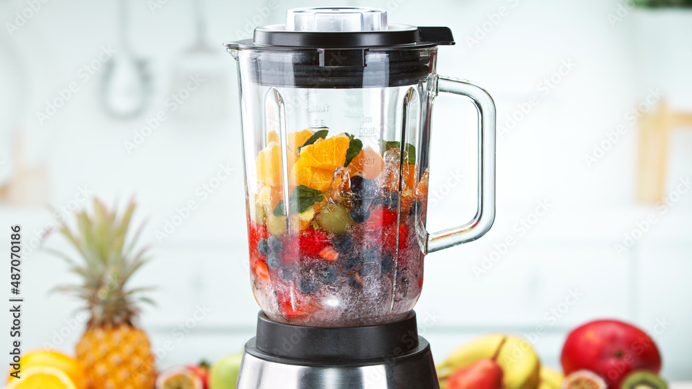 Mixing pieces of fruits and in blender. Preparation of healthy drink ...