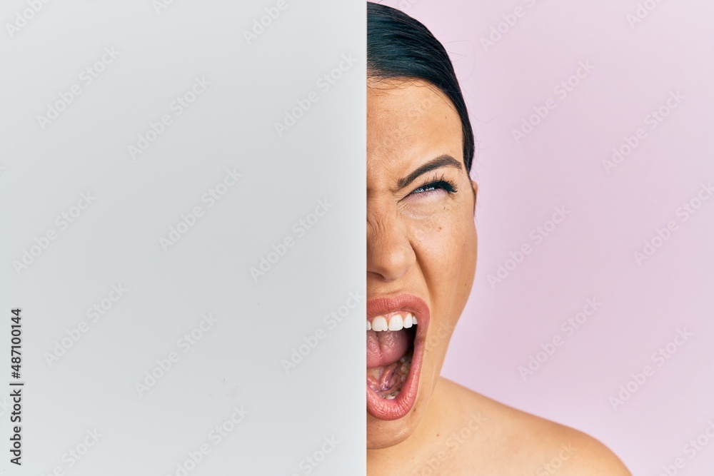 Beautiful brunette woman holding blank empty banner covering half face ...