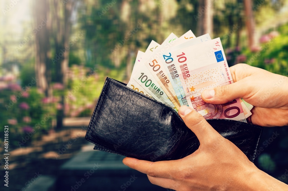 Hand taking out money from pocket wallet. Counting money, economy ...