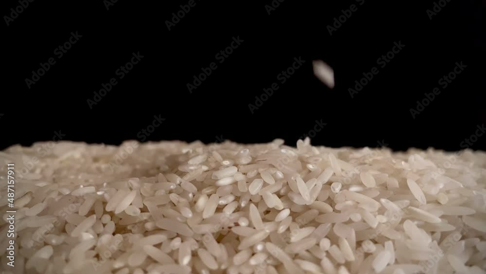 Dry uncooked rice is poured from top to bottom. Organic natural ...