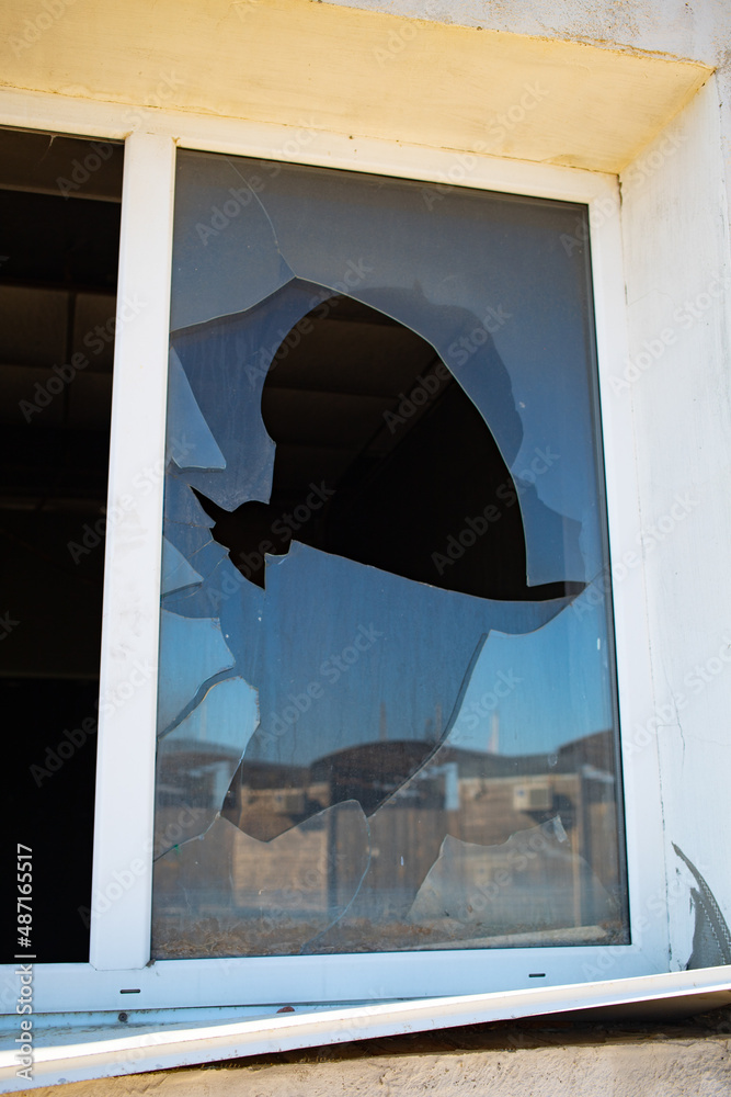 Broken glass window outside. Close up photo of a hole in a broken ...